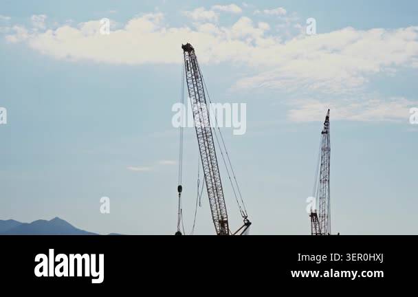 High resolution cinematic shot of a marine crane barge dredging the ...