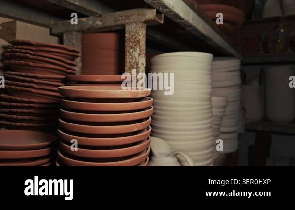 High quality close up shot of unfired terracotta clay bowls and dishes ...