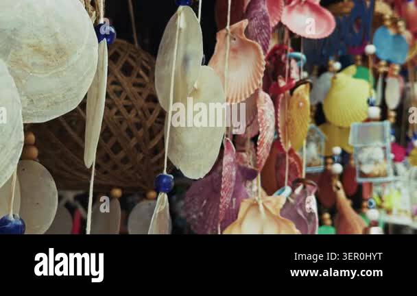 Cinematic high resolution shot of handmade seashell wind chimes and ...