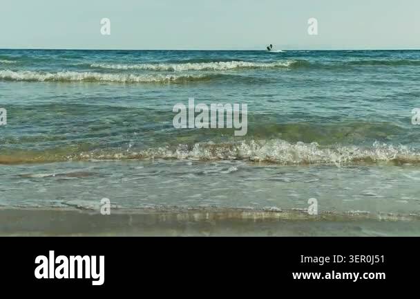Cinematic high resolution shot of a man riding a jet ski across the ...