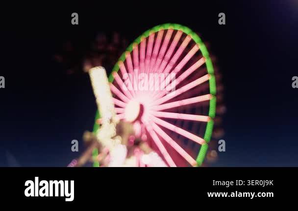 Defocused out of focus shot of spinning amusement park rides during ...