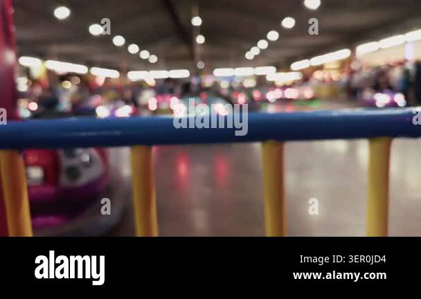 Defocused out of focus shot of spinning amusement park rides during ...
