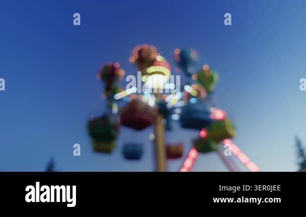Defocused out of focus shot of spinning amusement park rides during ...