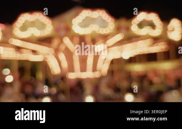 Defocused out of focus shot of spinning amusement park rides during ...