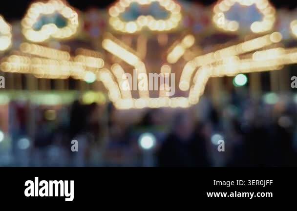 Defocused out of focus shot of spinning amusement park rides during ...