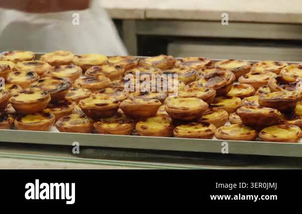 Large metal tray filled with traditional Portuguese custard tarts ...