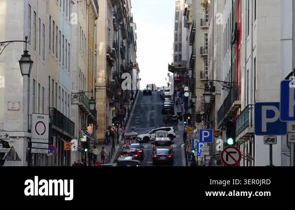 LISBON, PORTUGAL - MAY 15, 2026: A steep uphill city street packed with ...