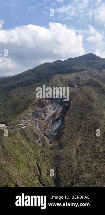 Panoramic aerial view of a verdant mountain range with a visible ...