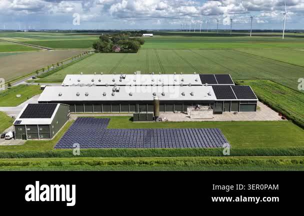 Modern farm using sustainable power sources with solar panels installed ...