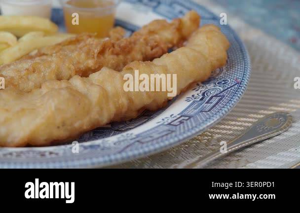 People eat fish and chips at a restaurant near the sea Stock Video ...