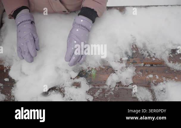 A person is playing in the snow with gloves on. Snow is everywhere ...