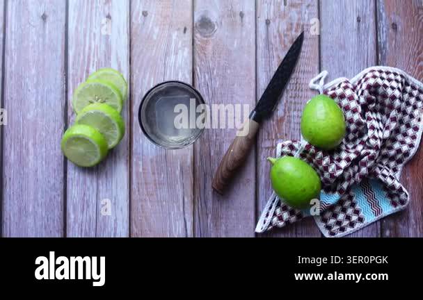 Slicing fresh limes for juice preparation on a wooden table Stock Video ...