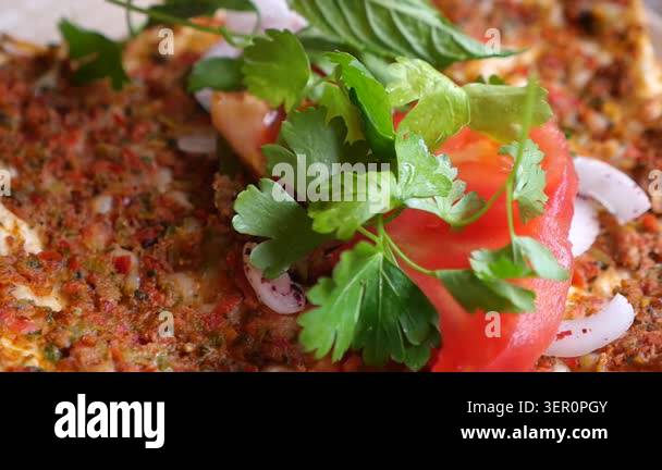 This dish is Lahmacun, a popular Turkish flatbread often referred to as ...