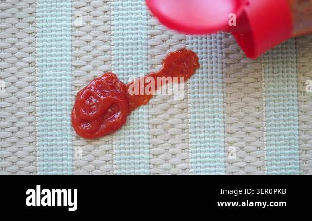 Ketchup spills from a bottle onto a tablecloth while eating Stock Video ...