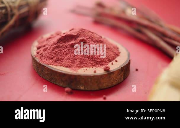 Vibrant Red Natural Powder on Wooden Coaster with Herbs Stock Video ...