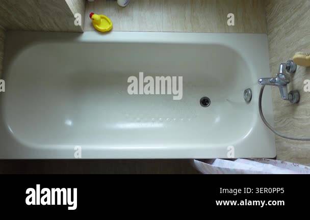 A bathtub is shown with a toy duck on the side in a bathroom Stock ...
