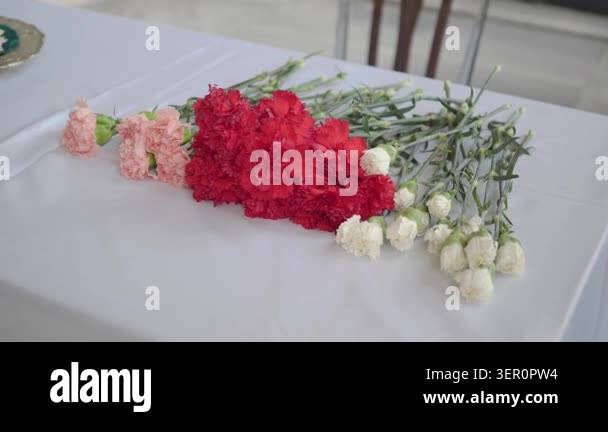 A group of flowers is arranged on a table for an event Stock Video ...