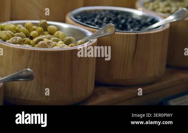 People taste different olives at a market during autumn months Stock ...