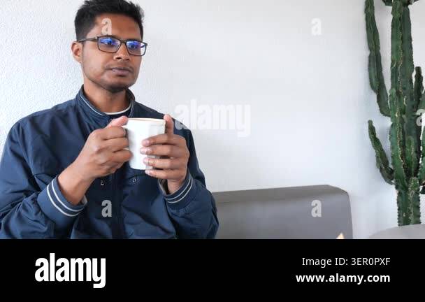 A man sits quietly with a cup of coffee in a cafe Stock Video Footage ...