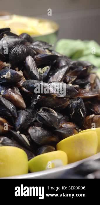 Mussels are cleaned and served with slices of lemon in kitchen Stock ...