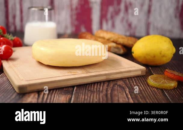 Round Cheese Wheel on Wooden Board with Fresh Ingredients Stock Video ...