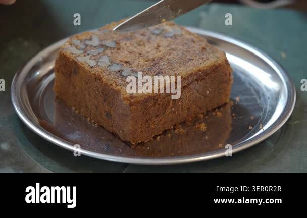Person Cutting a Slice of Walnut Loaf Cake on a Plate Stock Video ...