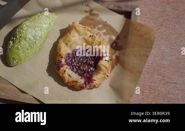 People are eating pastries at a cafe in the afternoon light Stock Video ...