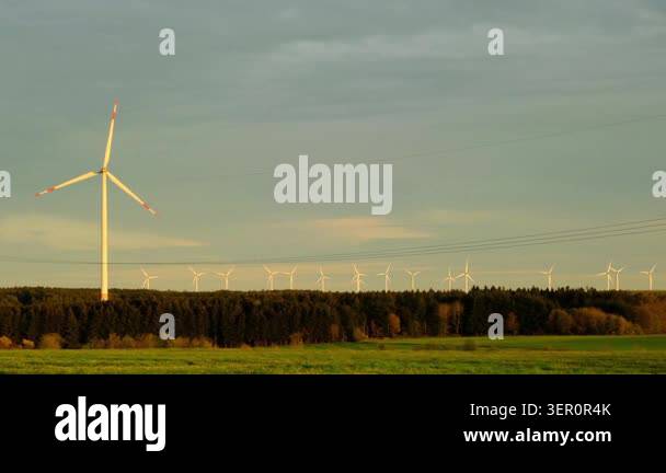 Wind Energy. A row of wind turbines in an autumn forest.Alternative ...