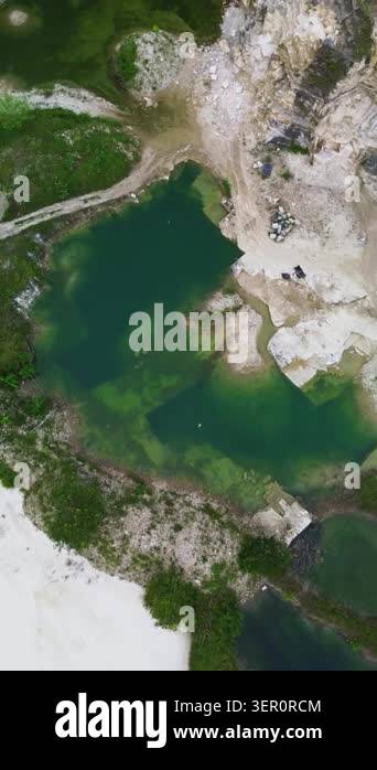 4K aerial footage of a former limestone quarry flooded by rainwater and ...