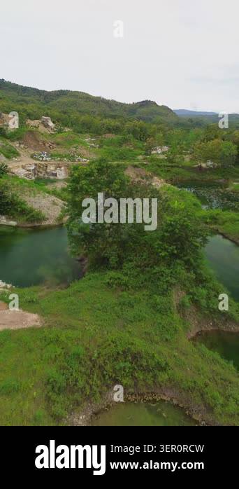 4K aerial footage of a former limestone quarry flooded by rainwater and ...