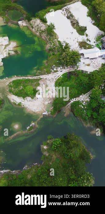 4K aerial footage of a former limestone quarry flooded by rainwater and ...
