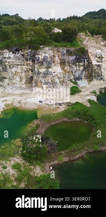 4K aerial footage of a former limestone quarry flooded by rainwater and ...