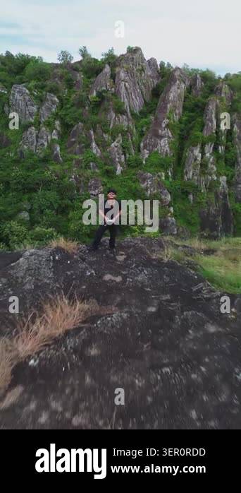 4K aerial footage of an Asian man flying a drone over a beautiful ...