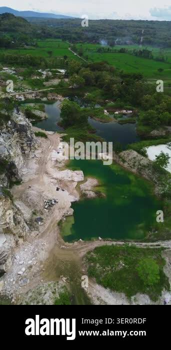 4K aerial footage of a former limestone quarry flooded by rainwater and ...