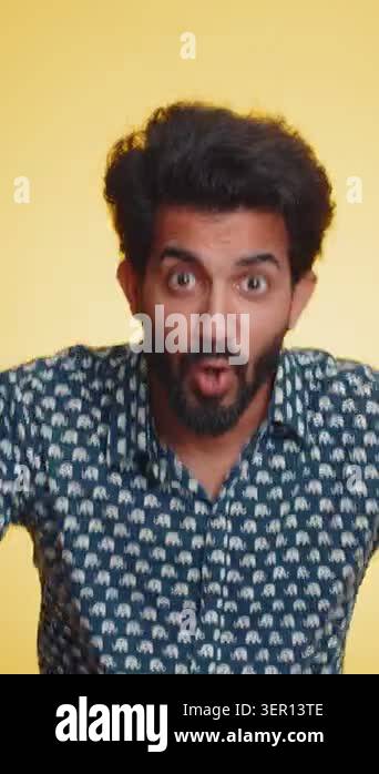 Excited amazed Indian man touching head and showing explosion, looking ...