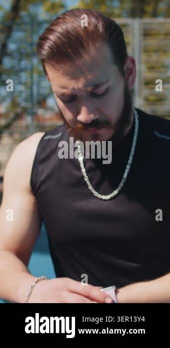 Athletic Lebanese man jogger in sportswear using smart watch, checking ...