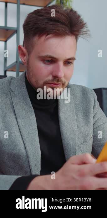 Oh my God, Wow. Happy amazed businessman in suit working on smartphone ...