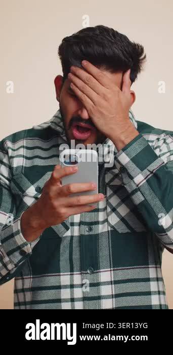 Indian man use mobile cell phone typing browsing, loses becoming ...