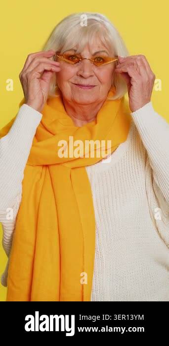 Portrait of seductive stylish senior old woman wearing orange ...