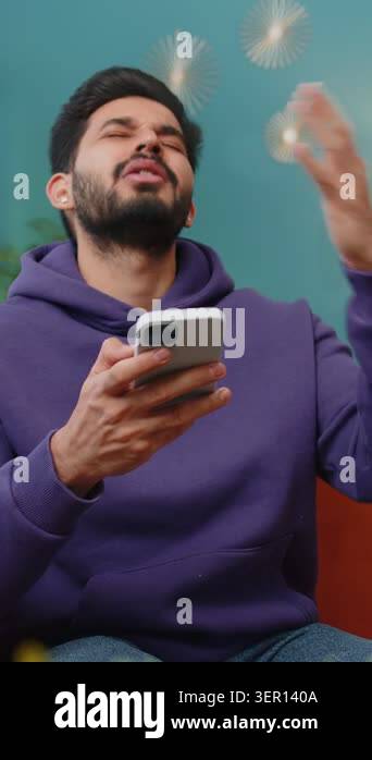 Sad displeased Indian man use smartphone typing browsing, loses ...