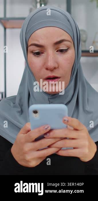 Oh my God, Wow. Amazed Muslim businesswoman in hijab working on ...