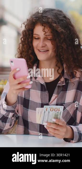 Happy rich woman counting money dollar cash, use smartphone calculator ...