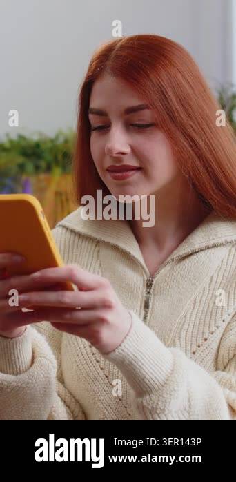 Happy young woman use mobile smartphone typing browsing say Wow yes ...