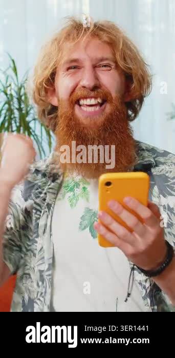 Happy man use mobile smartphone typing browsing say Wow yes ...
