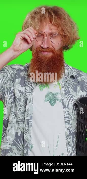 Redhead man taking off throwing out glasses into bin after medical ...