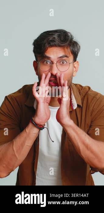 Keep my secrets, silence. Indian young man whisper news rumors holding ...