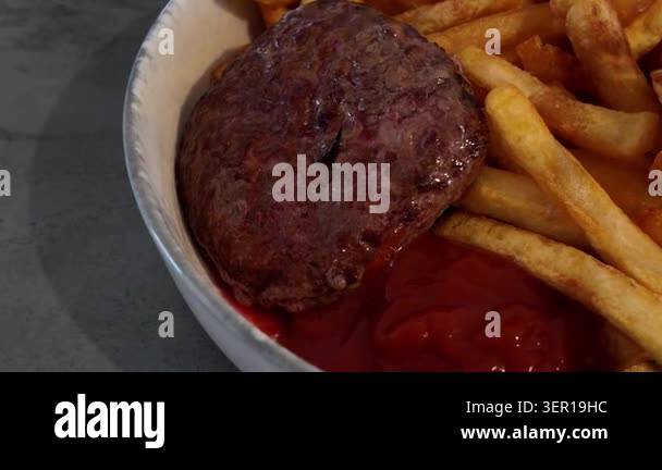 Plate of hamburger steak and fries close-up cinematic view. Macro shot ...