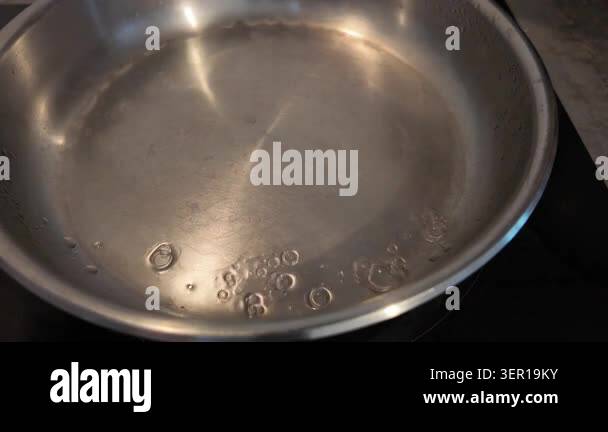 The water drop technique for cooking with stainless steel pans Stock ...