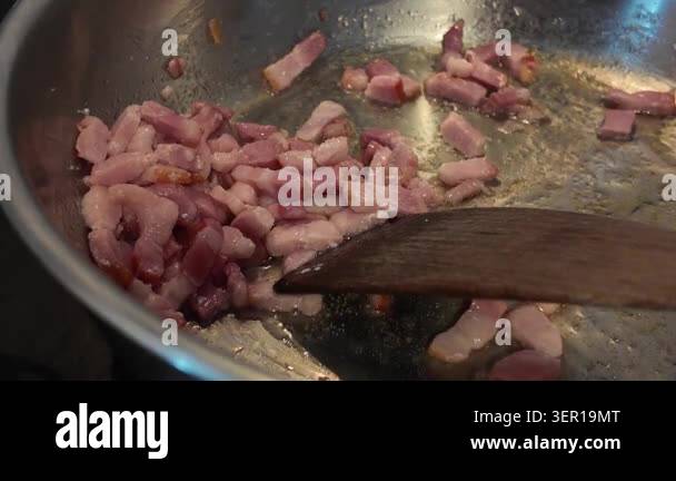 Cooking pork bacon bits close-up cinematic view. Macro shot of cooking ...