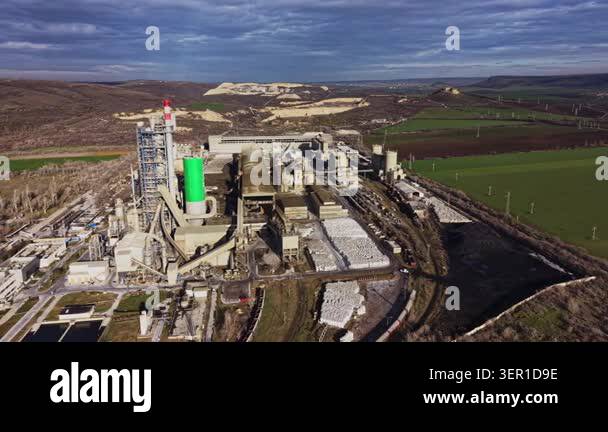 A large power plant is located in a rural area. The site has tall ...